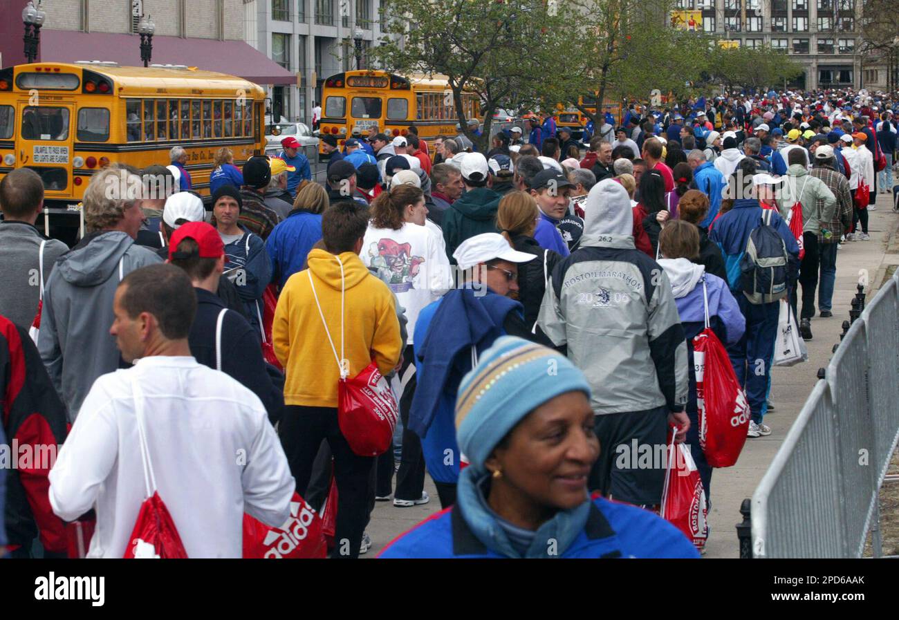 The 110th Boston Marathon runners line up to board buses, Monday, April ...