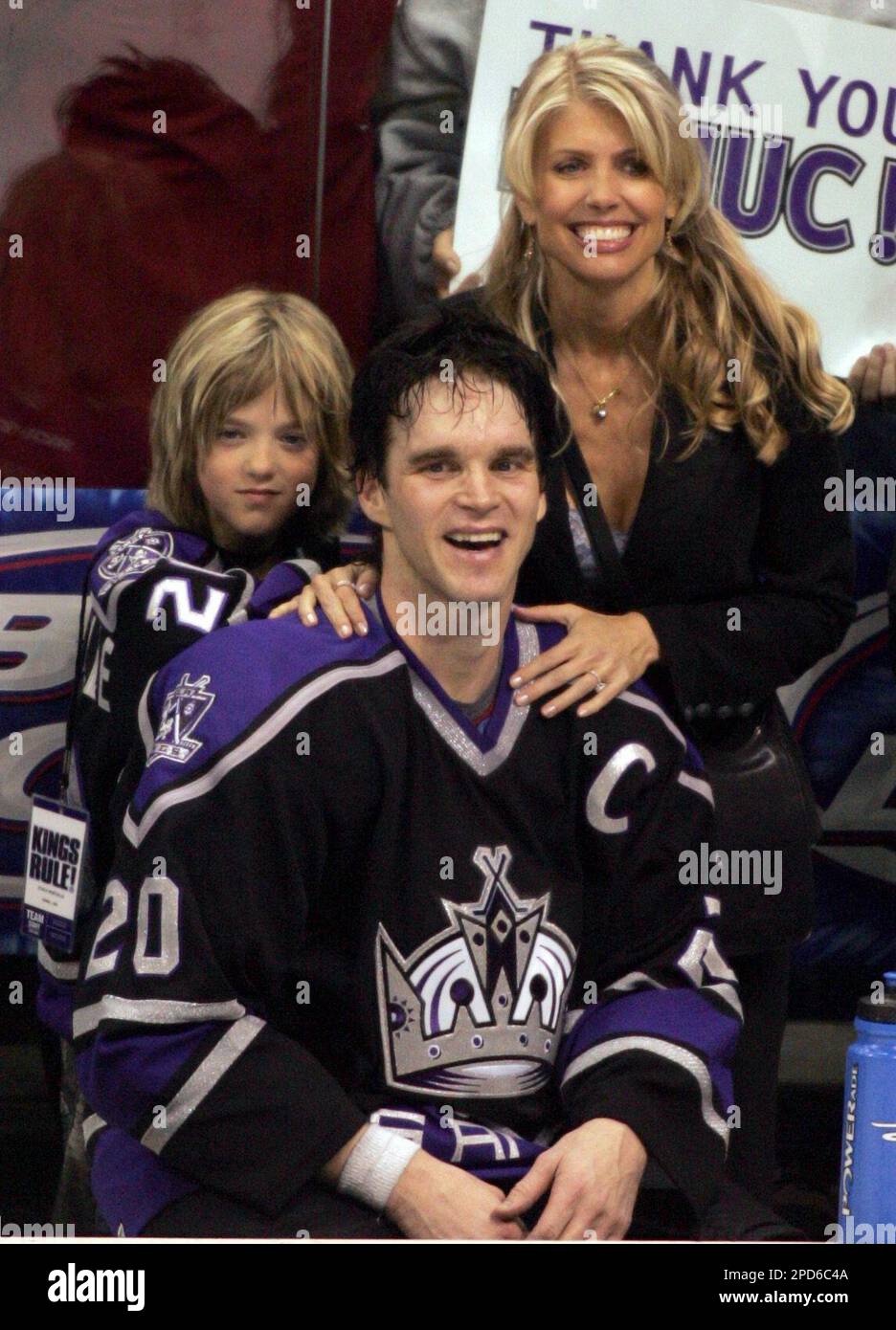 Los Angeles Kings' Luc Robitaille sits on the bench with his wife ...