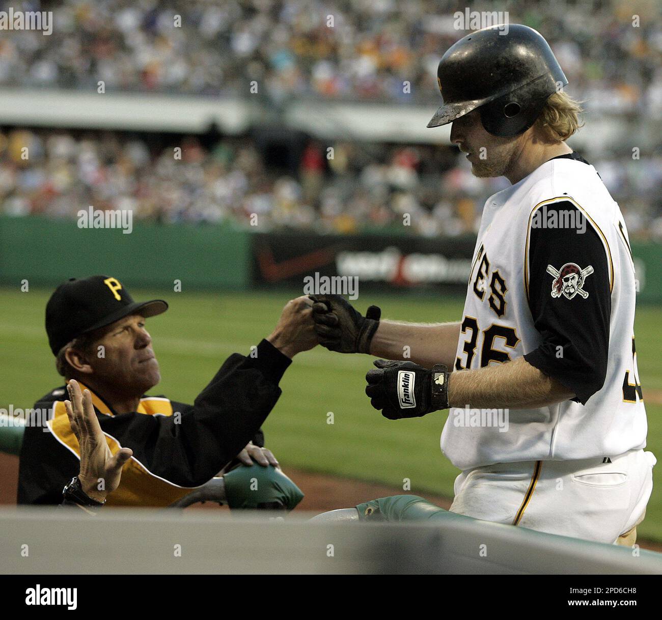 Pittsburgh Pirates' Craig Wilson is greeted by manager Jim Tracy, left ...
