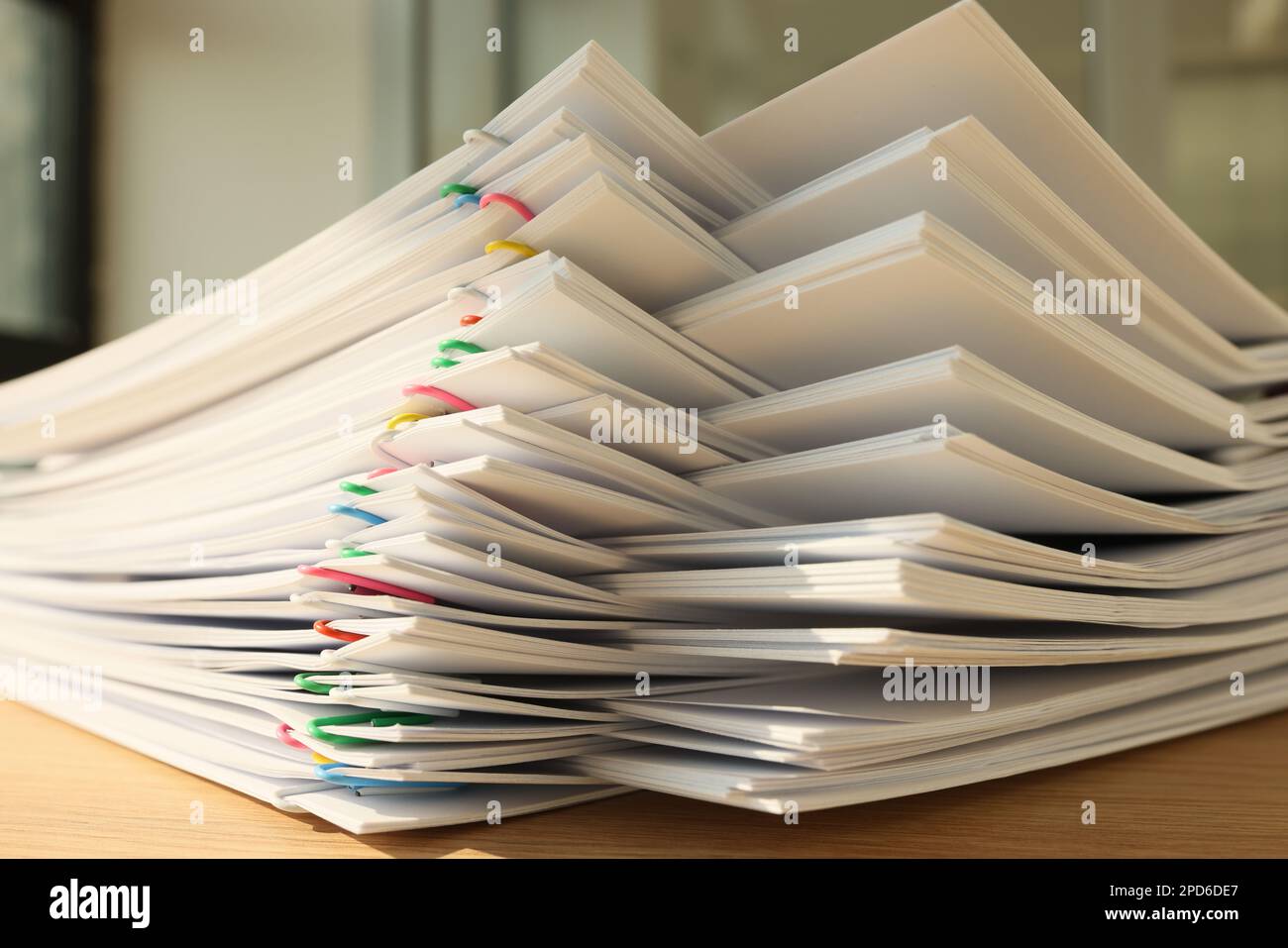 High stack of office documents with clips on office table close up ...