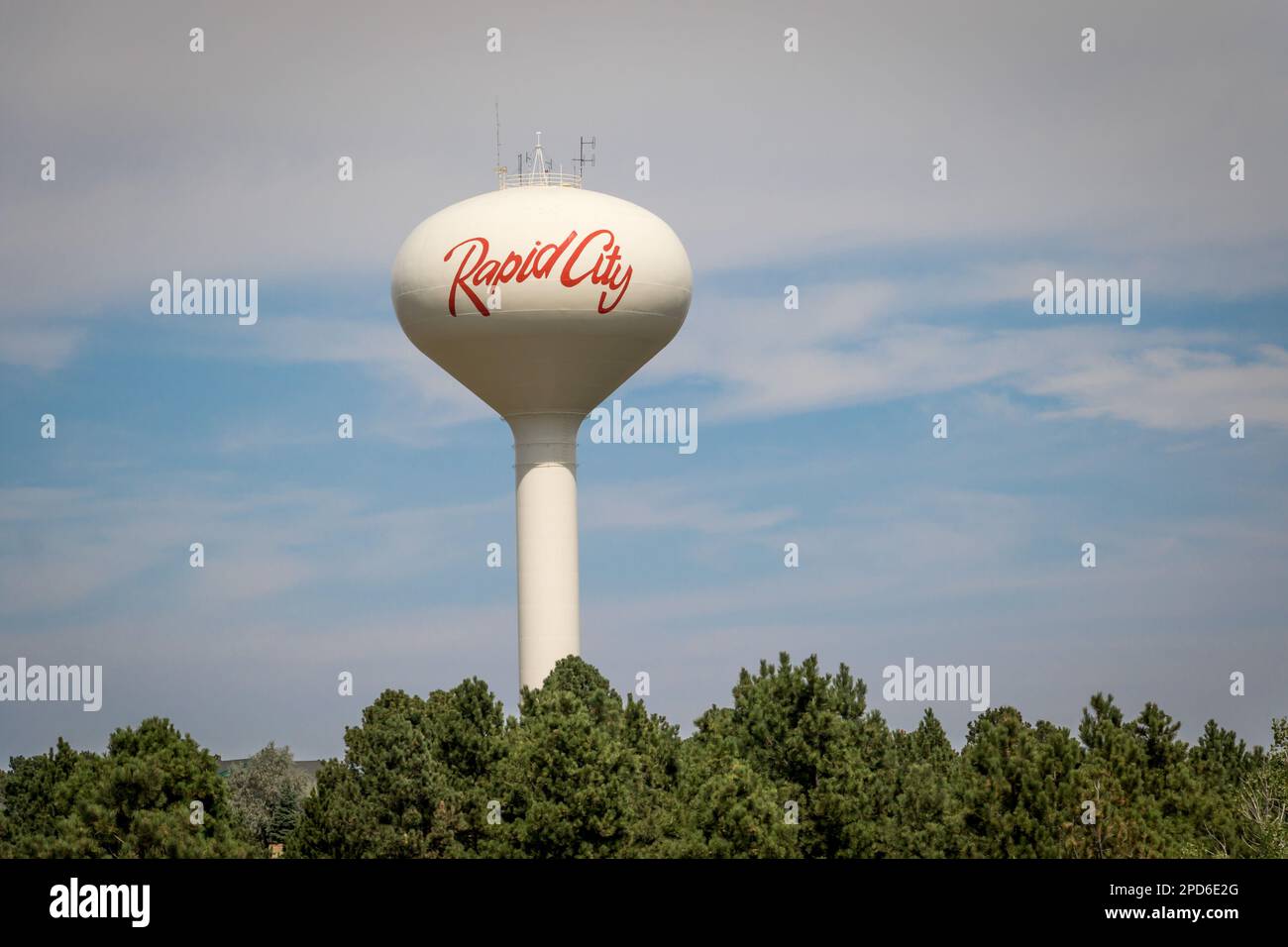 A white round water tower with Rapid City printed in red on the side ...