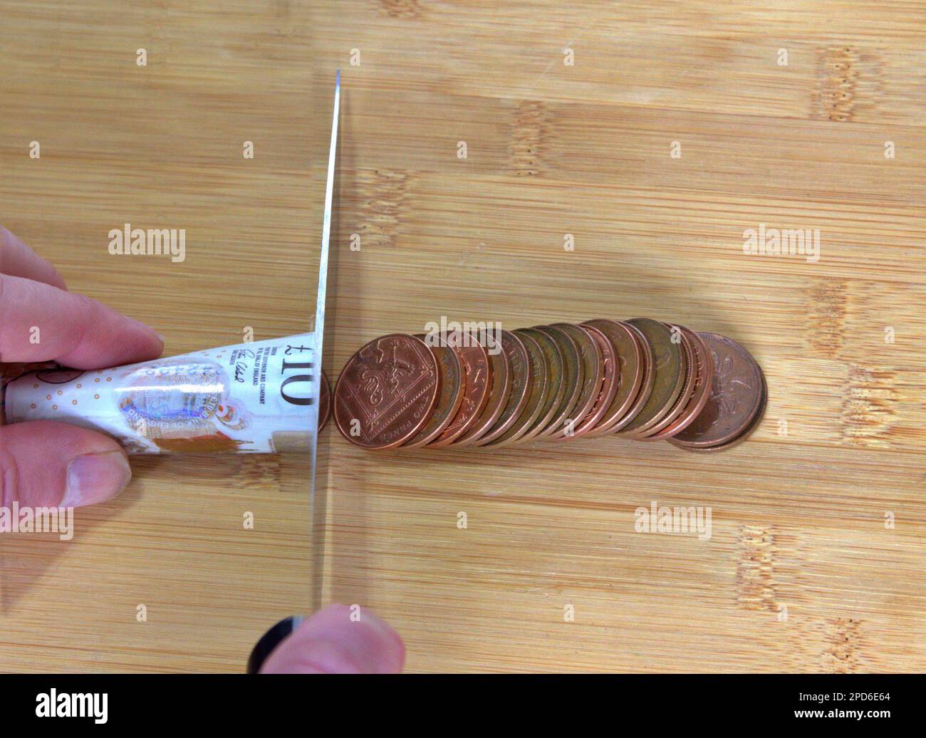 Cutting coins hi-res stock photography and images - Alamy