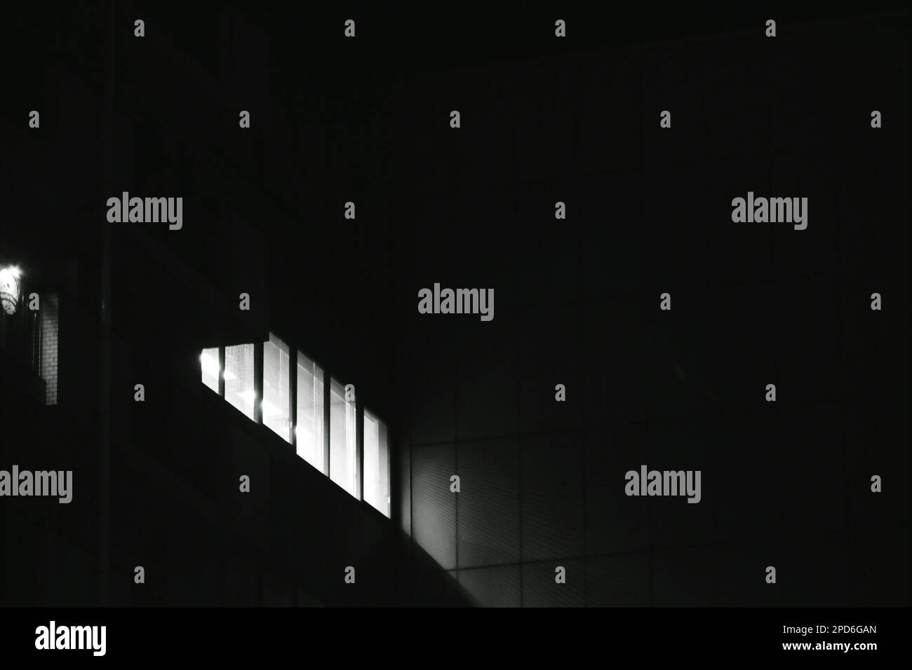 light sift out from building window ajar in night Stock Photo - Alamy