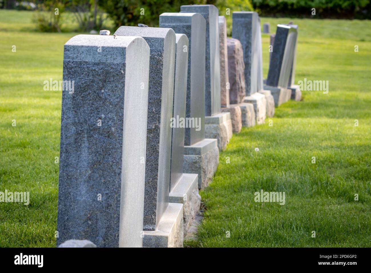 A row of stone grave markers at a cemetery Stock Photo - Alamy