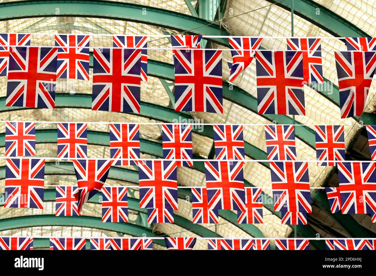Rows of Union Jack flags hanging over an indoor market Stock Photo - Alamy