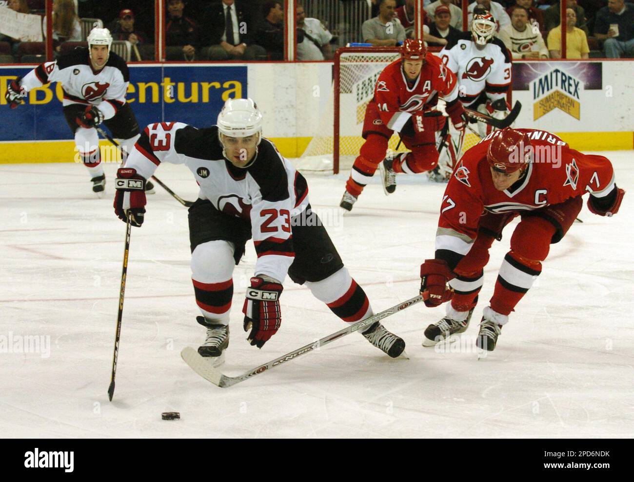 New Jersey Devils' Scott Gomez (23) beats Carolina Hurricanes' Rod ...