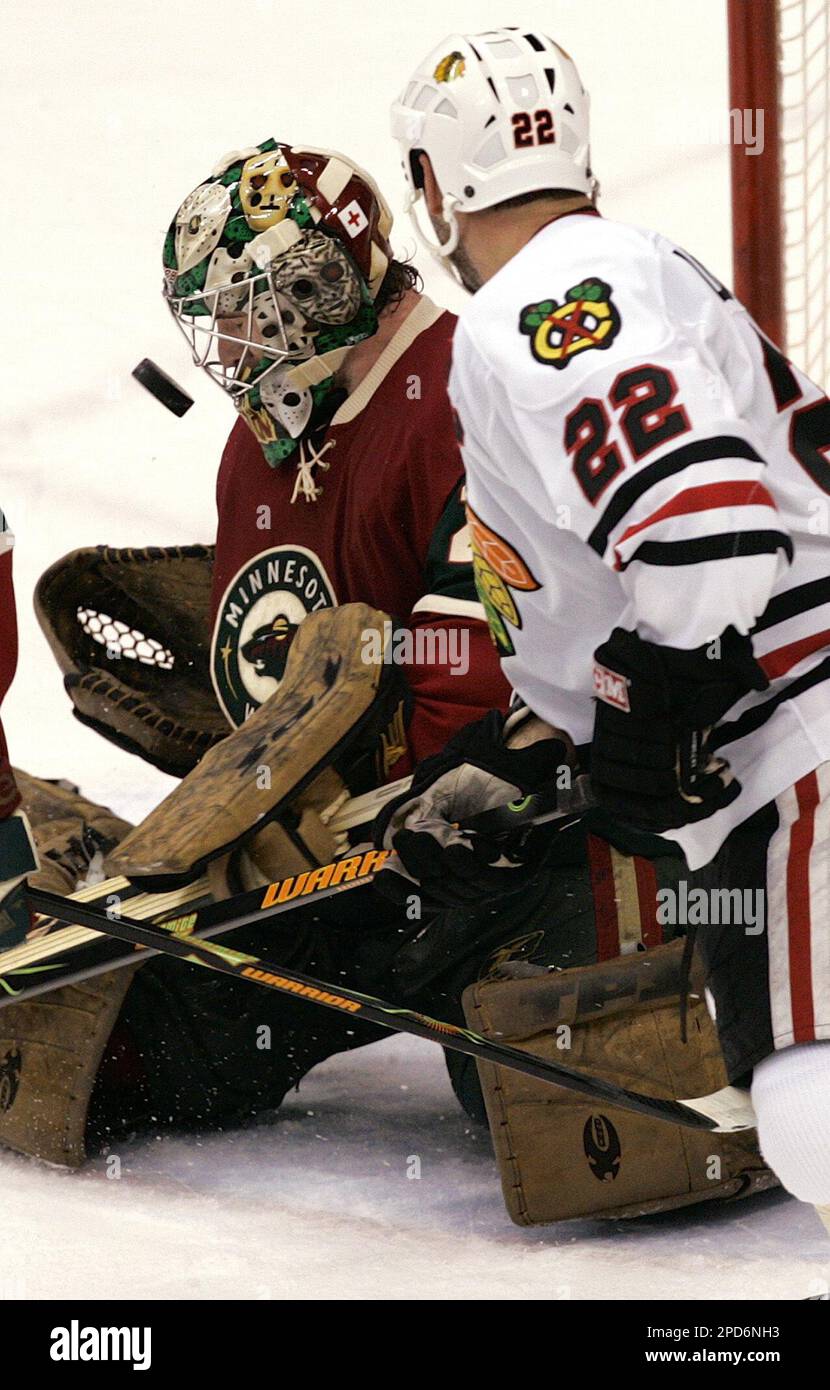 Minnesota Wild goalie Josh Harding, left, blocks a shot by Chicago ...
