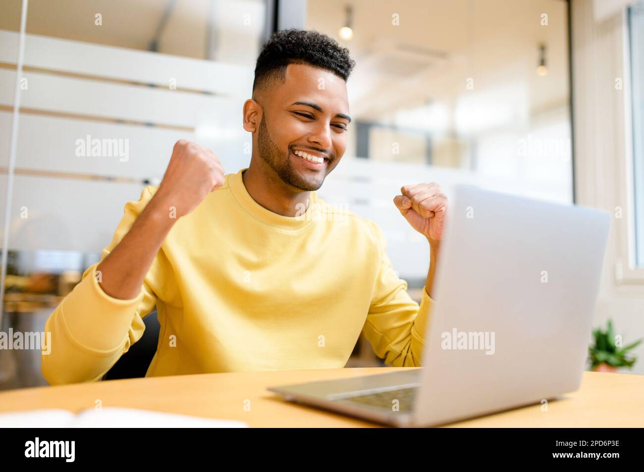 Excited Pakistani businessman looking at the laptop screen and ...
