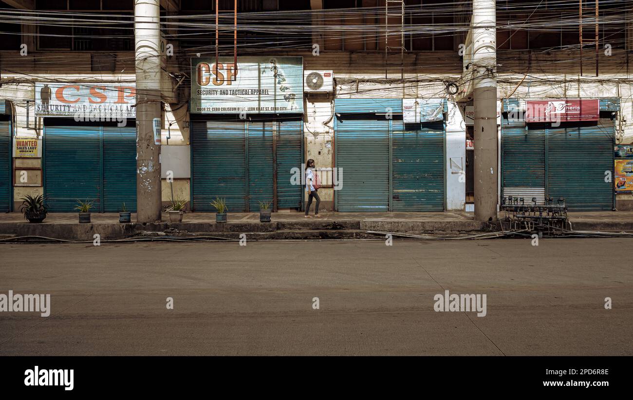 A derelict urban building with shuttered storefronts and graffiti ...