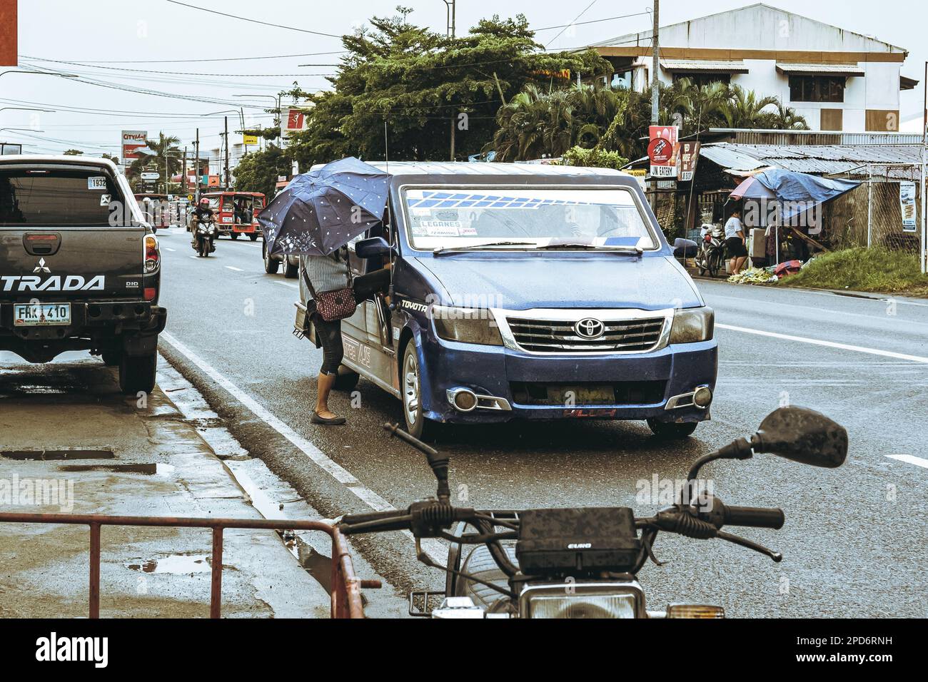 A street view with some cars and motorcycles in the Philippines Stock ...