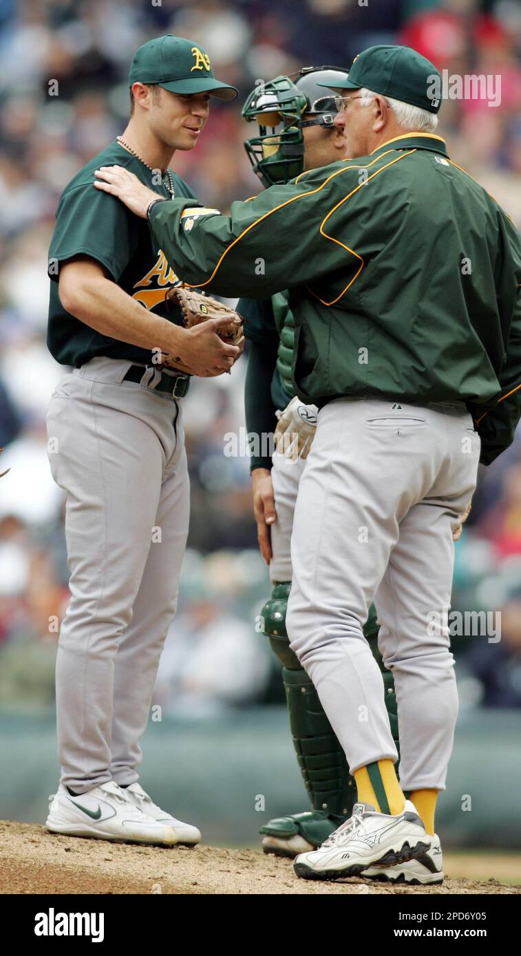 Oakland Athletics starting pitcher Rich Harden, left, receives a pat on ...