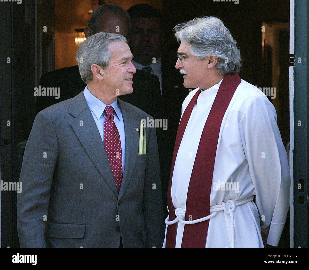 President Bush stands with with Rev. Luis Leon before departing St ...