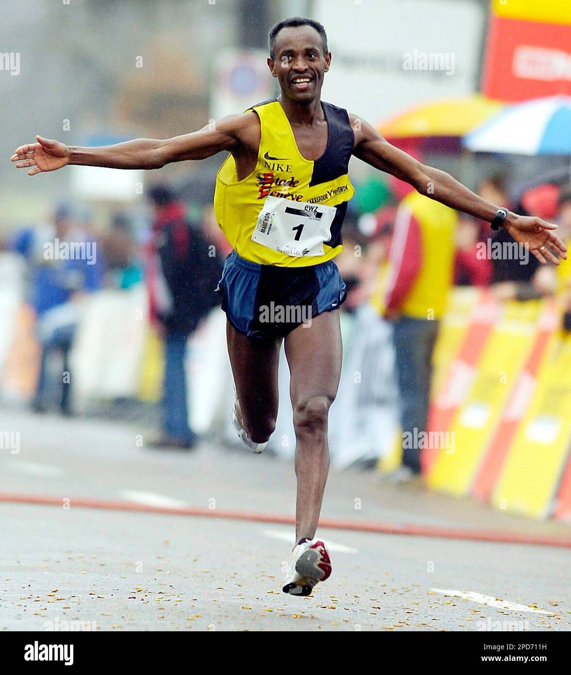 Eticha Tesfaye of Ethiopia celebrates prior to crossing the finish line ...