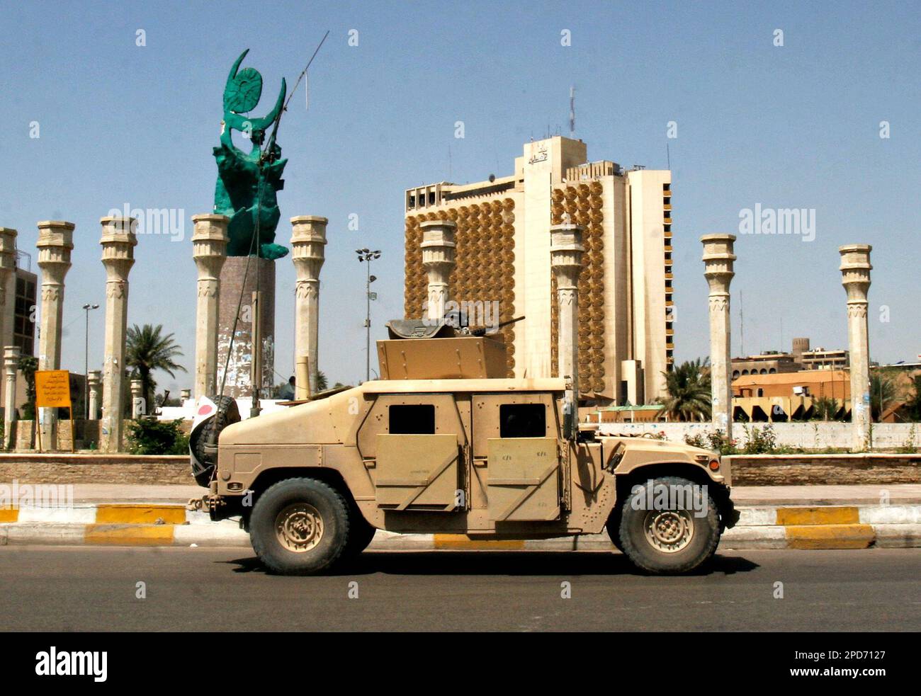 US soldiers in a Humvee patrol past the sculpture nicknamed "Freedom ...