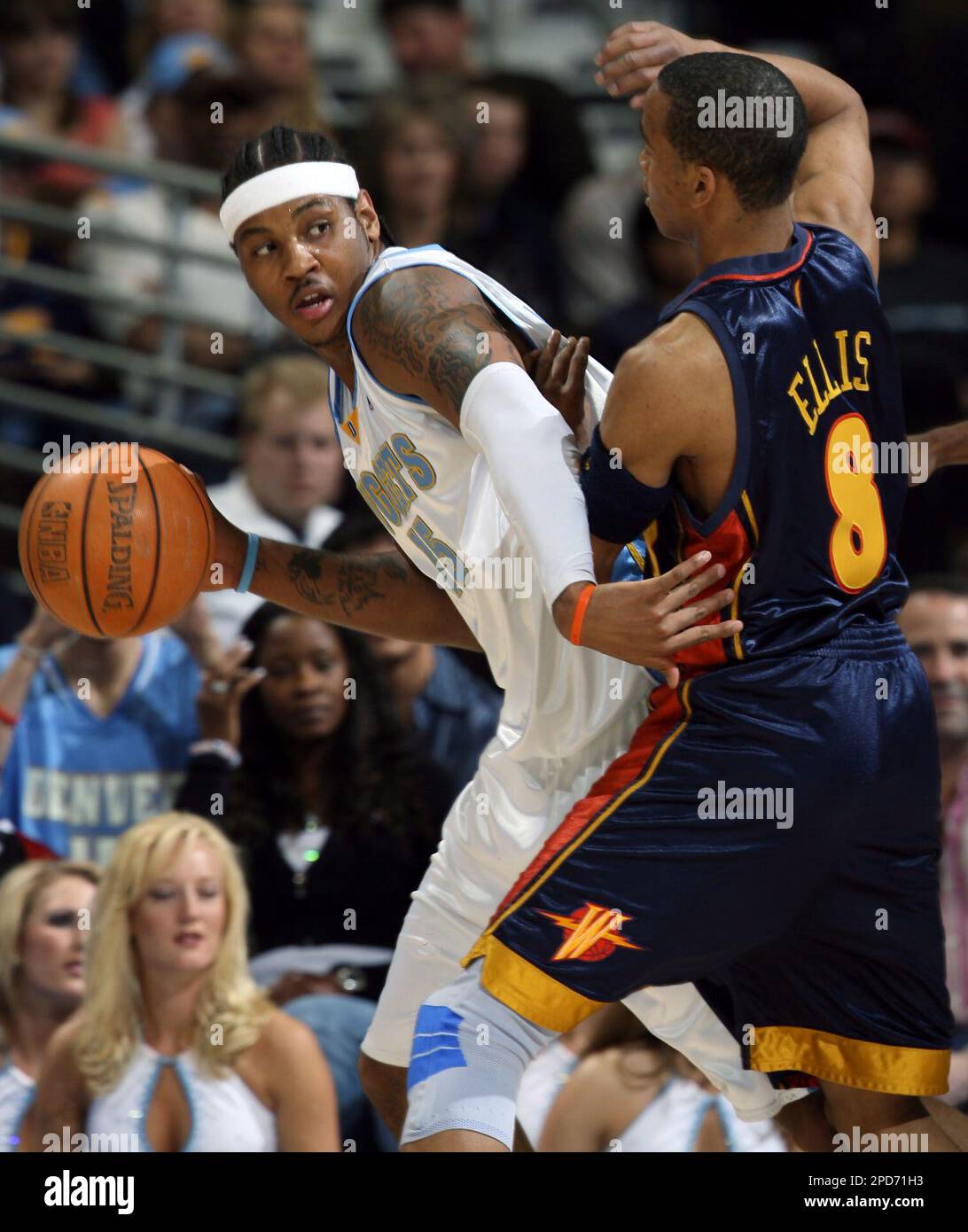 Denver Nuggets forward Carmelo Anthony, left, looks to pass the ball as ...