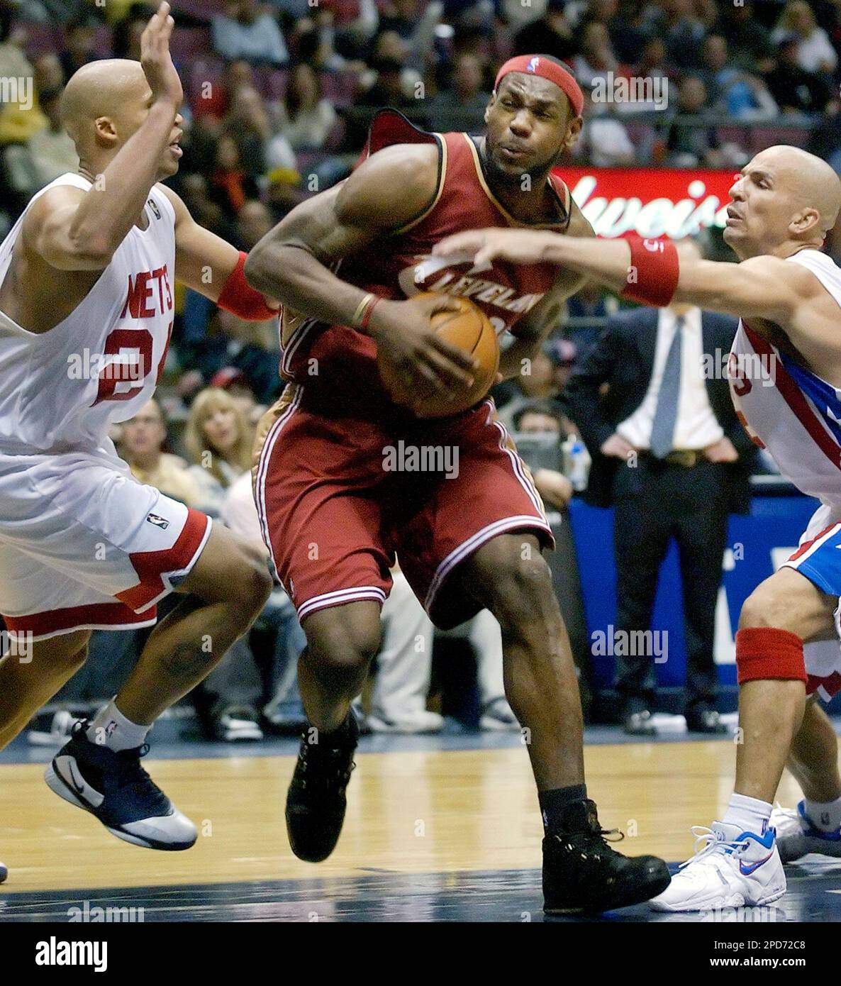 Cleveland Cavaliers' LeBron James splits the defense of New Jersey Nets ...