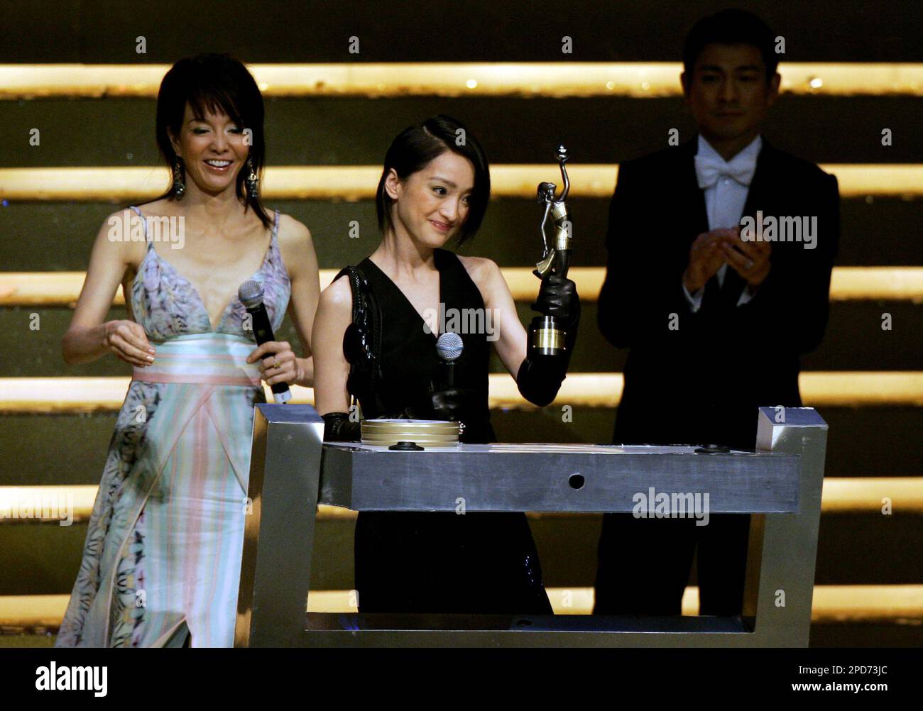 Mainland China's actress Zhou Xun raises her trophy for the Best ...