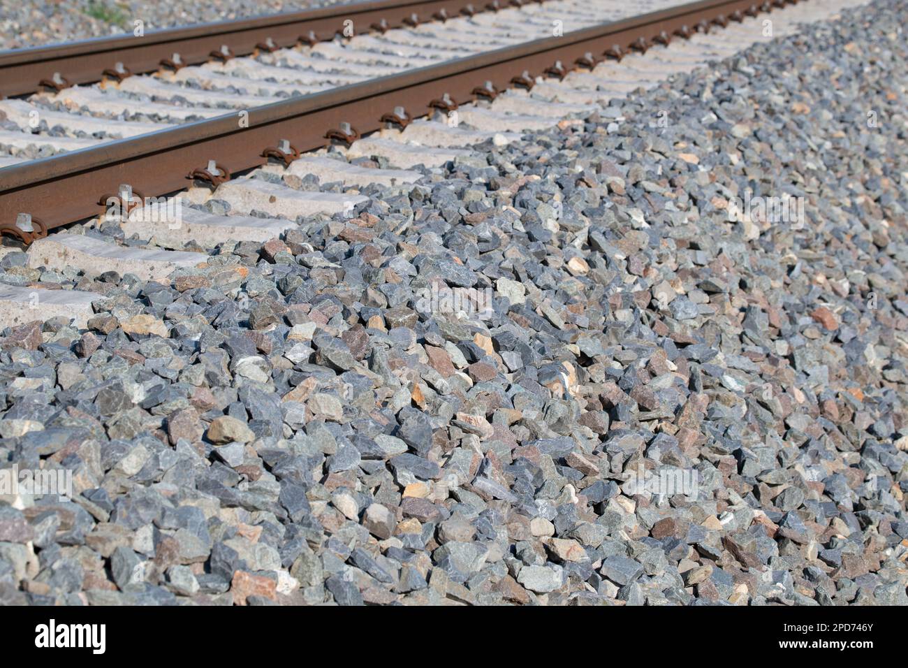 Railway track in the gravel bed in a close-up Stock Photo - Alamy
