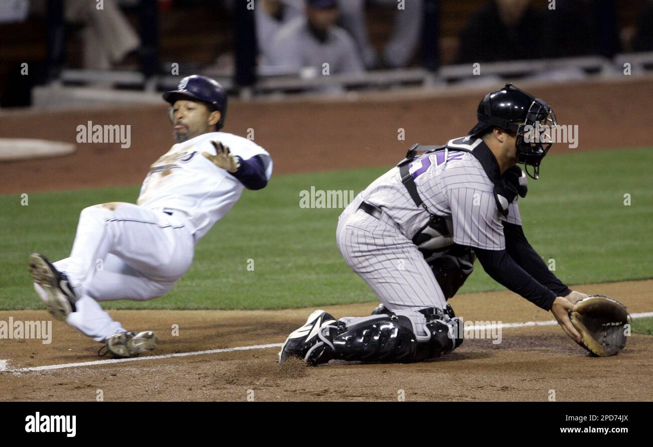 San Diego Padres' Dave Roberts, left, slides past Colorado Rockies ...