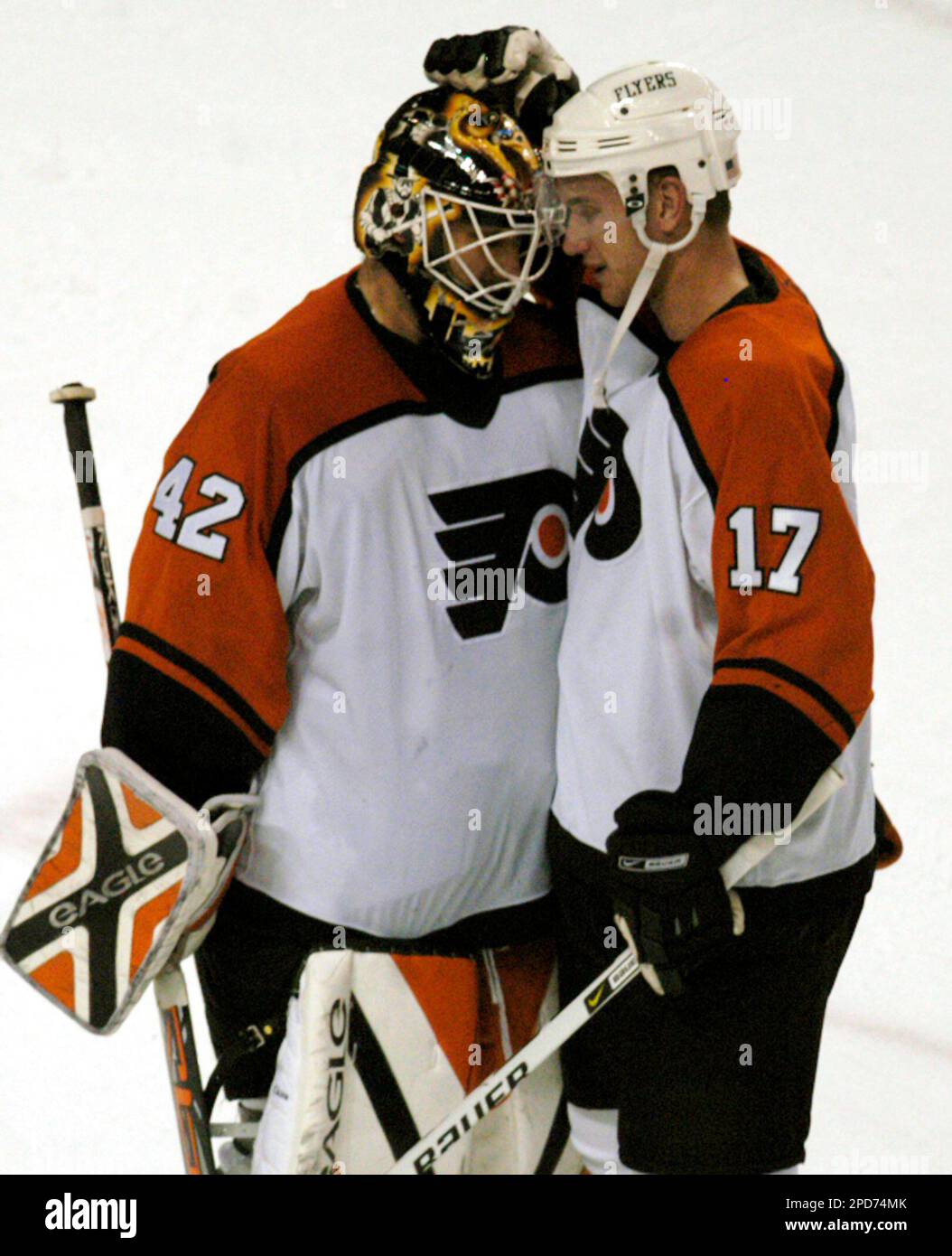 Philadelphia Flyers goalie Robert Esche (42) is congratulated by Flyers ...