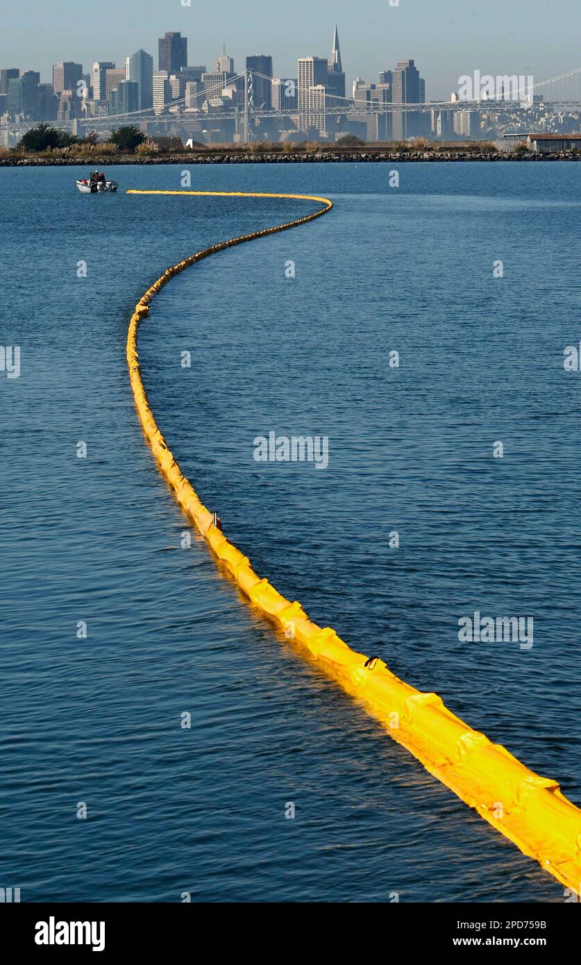 Personnel with NRC Environmental Services deploy containment boom near ...