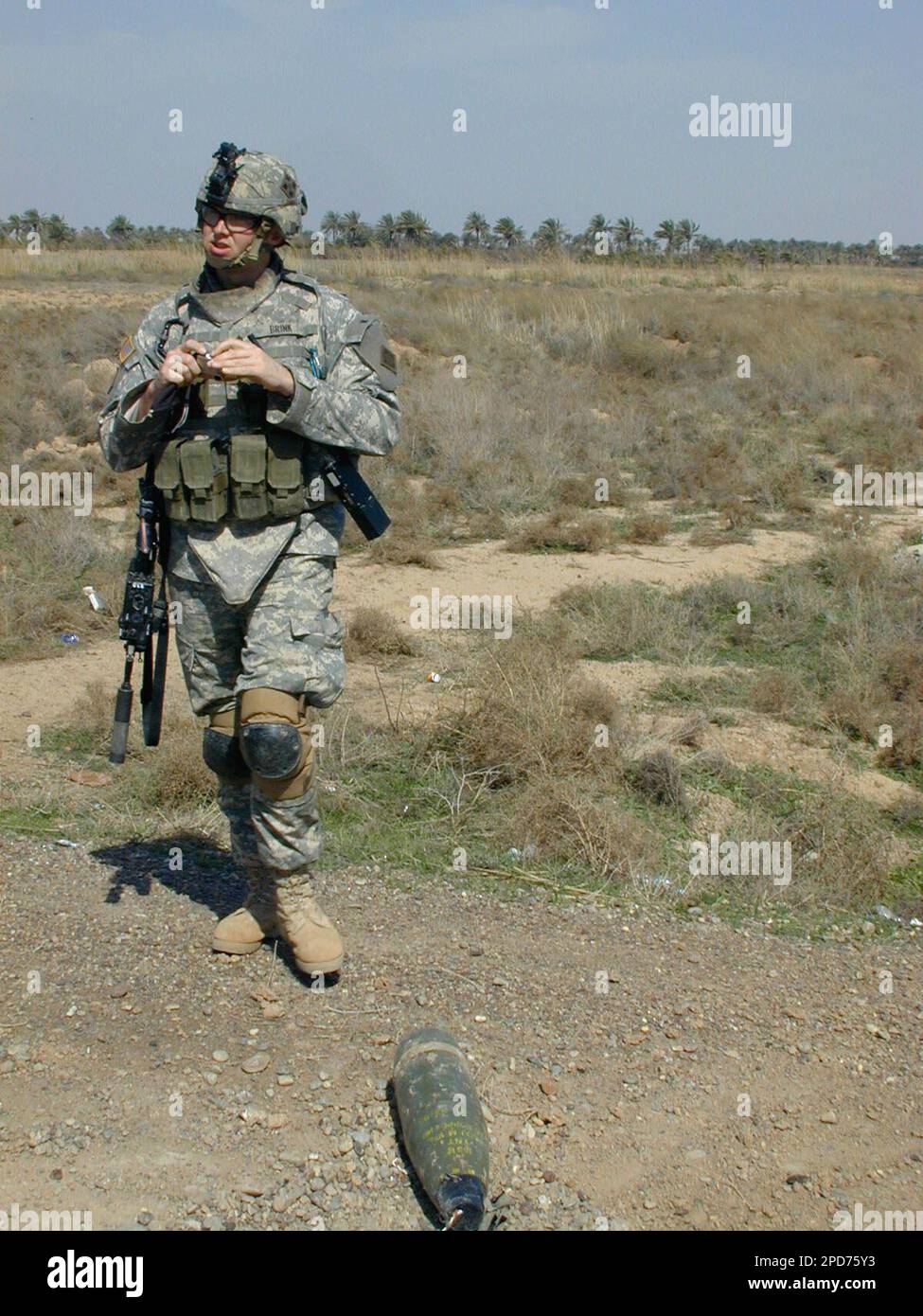 A member of the 9th Cavalry Regiment takes a look at an artillery shell ...