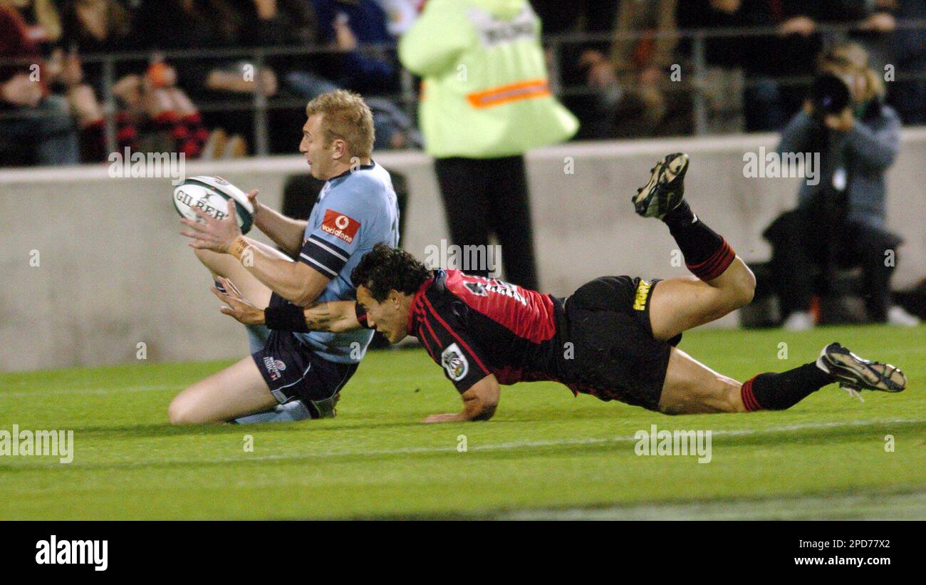 Waratahs' Peter Hewat, left, attempts to try as Crusaders' Rico Gear ...