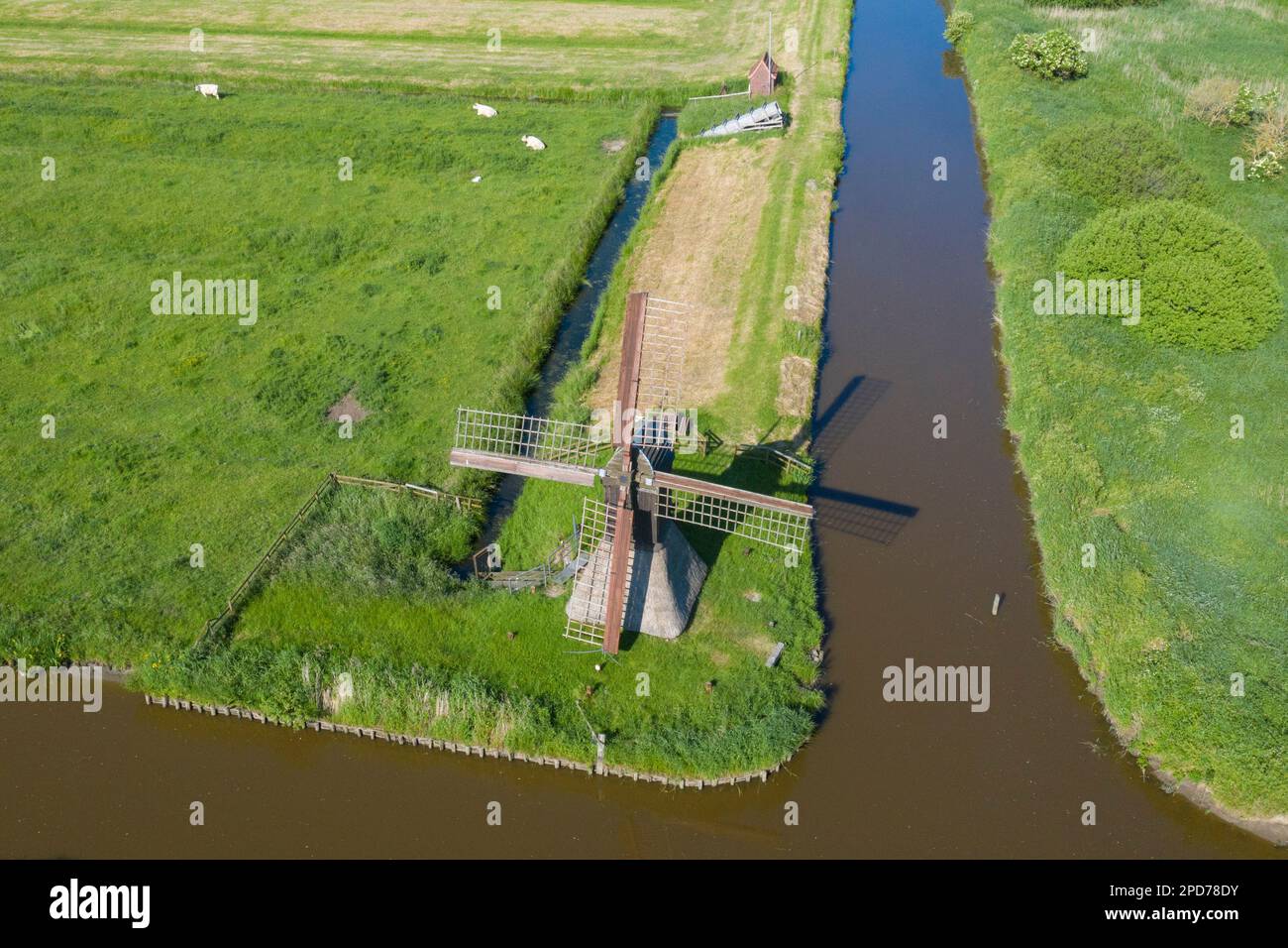 Aerial view over brook, meadows and windmill Honigfleth, last water ...