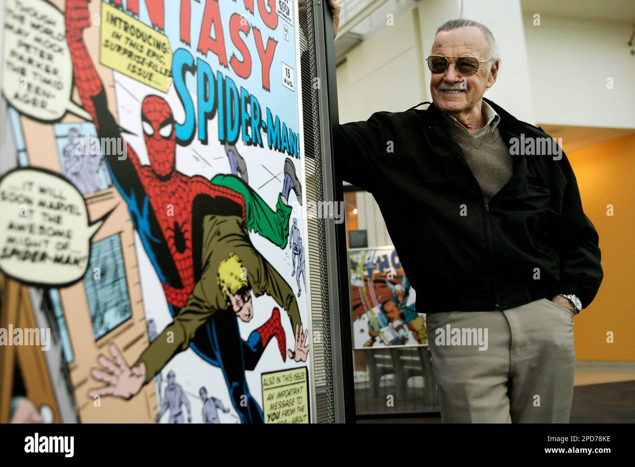 Comic book creator Stan Lee stands beside some of his drawings in the ...