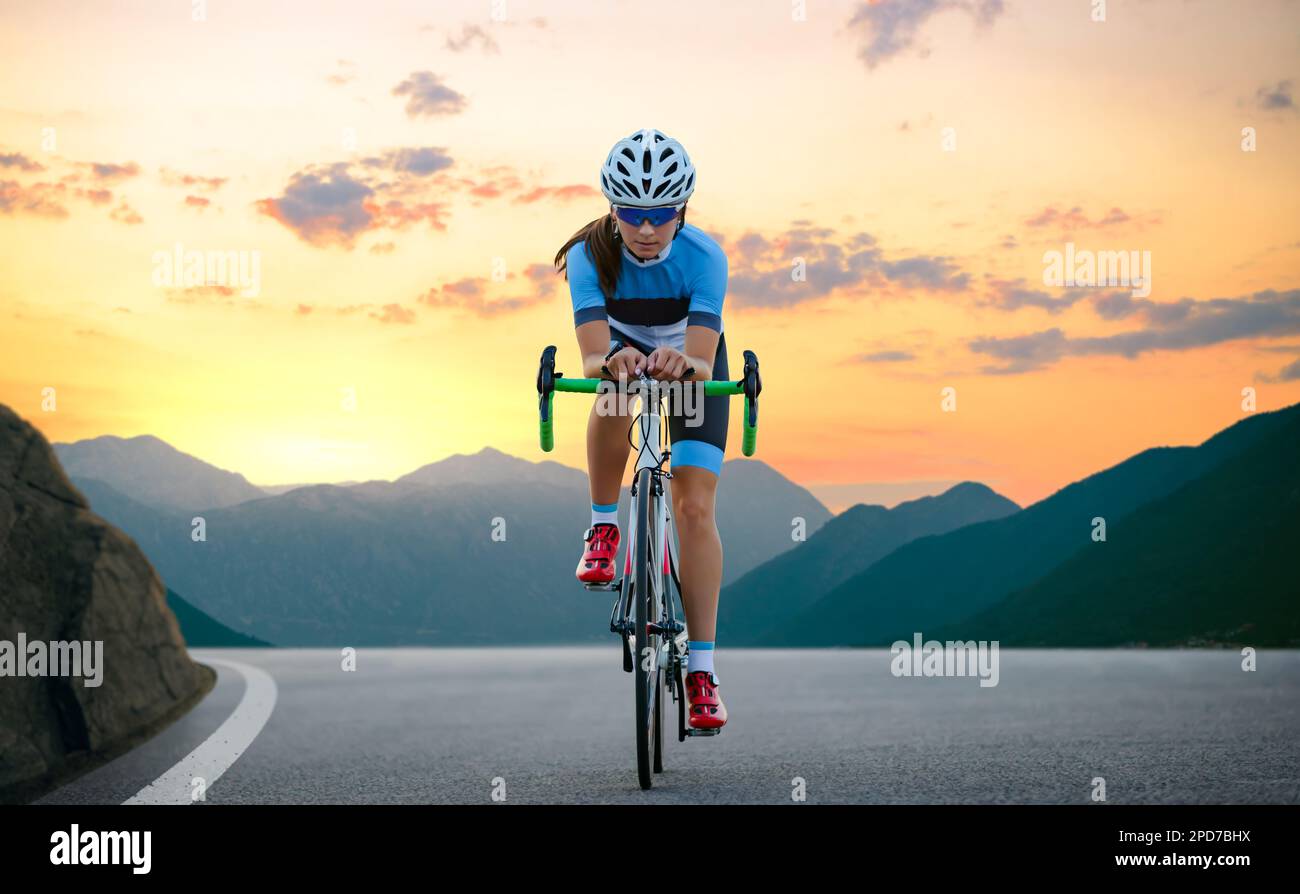 Woman Cyclist Riding Road Bike in the Beautiful Mountains at Sunset ...
