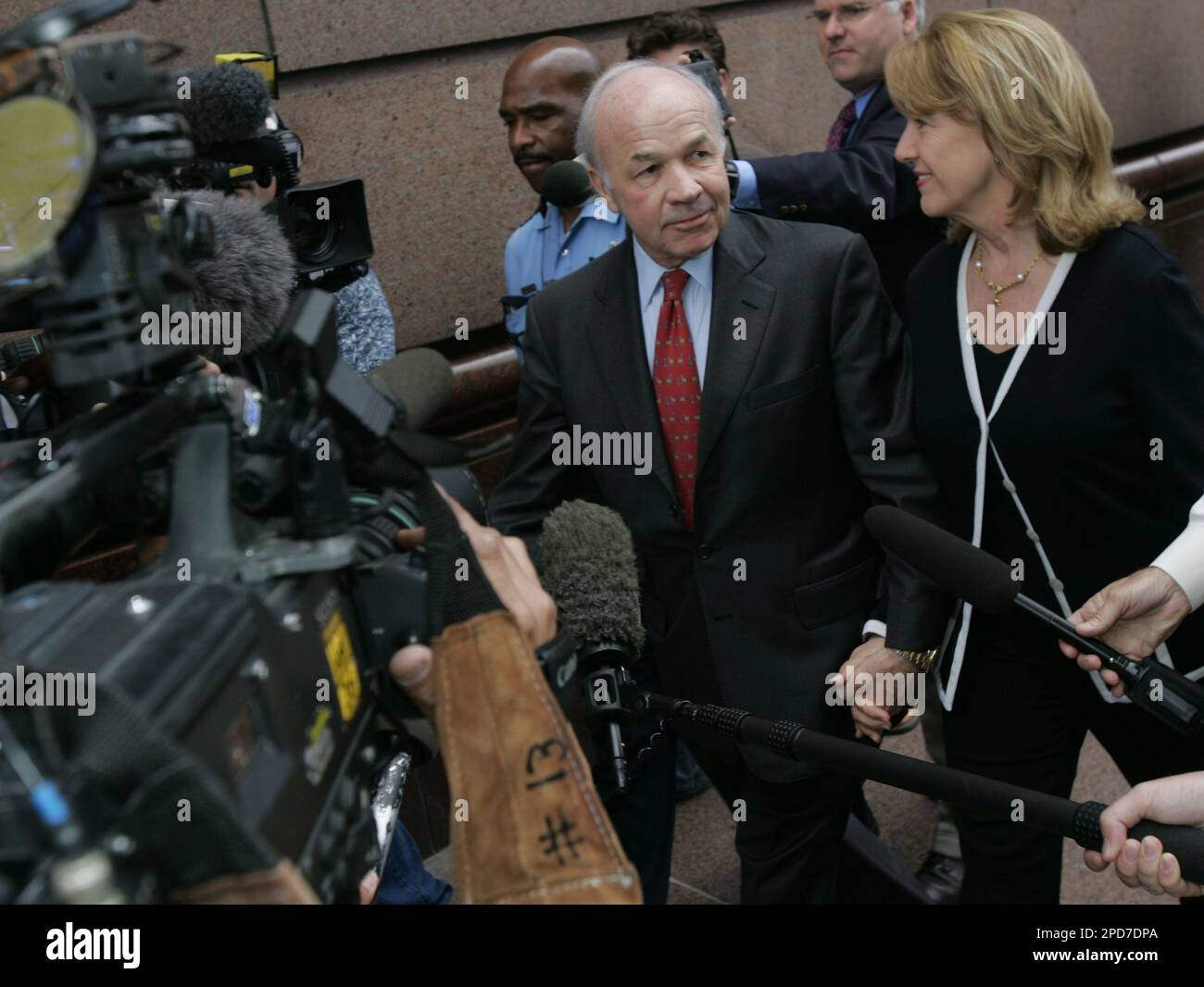 Enron founder Kenneth Lay and his wife Linda are surrounded by media as ...