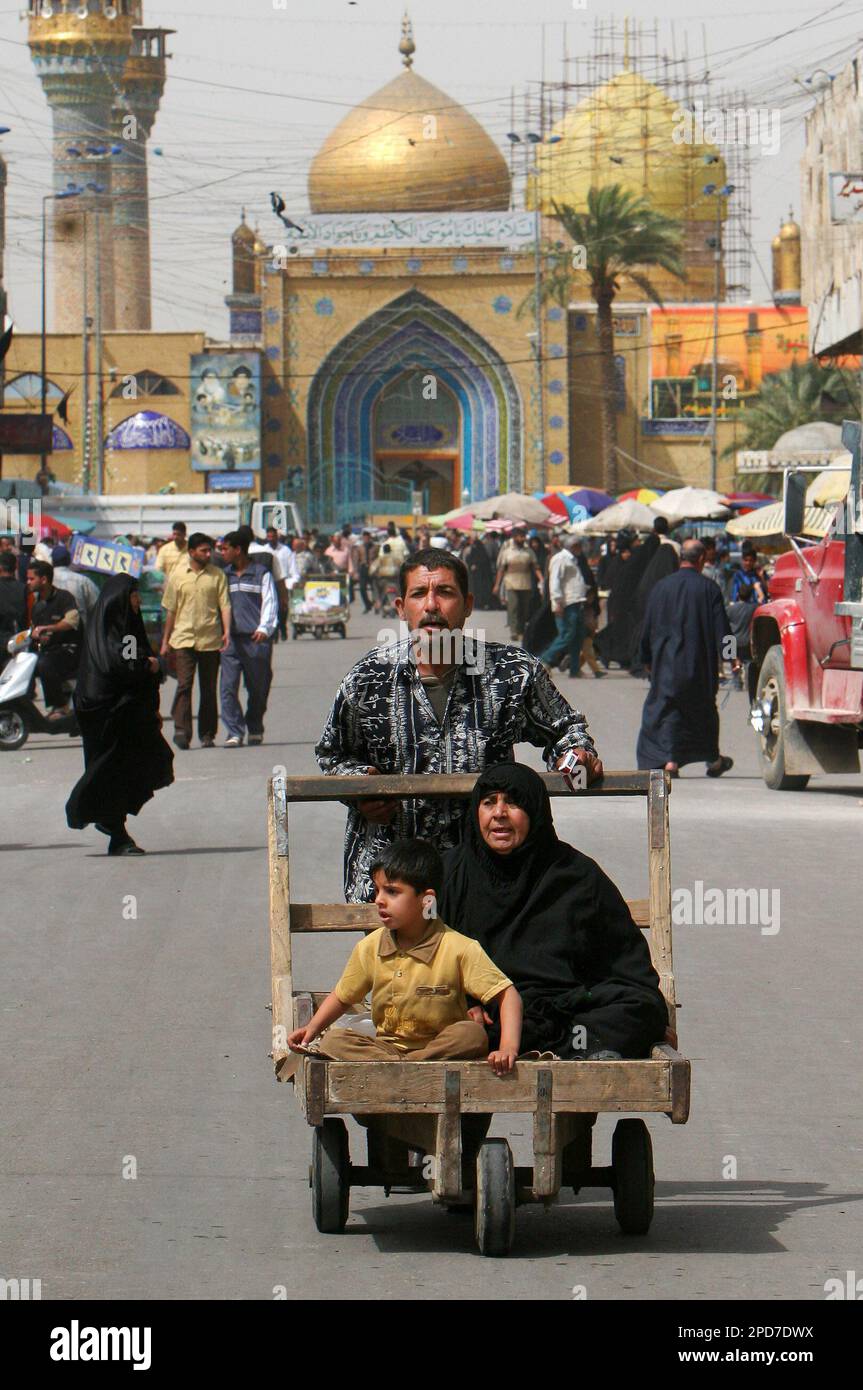 An Iraqi woman and child get a ride in a cart Wednesday April 5, 2006 ...