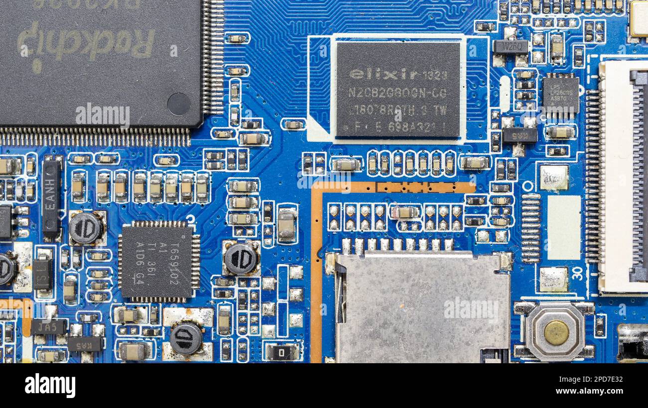 A closeup of a blue computer board featuring a motherboard, chips and ...