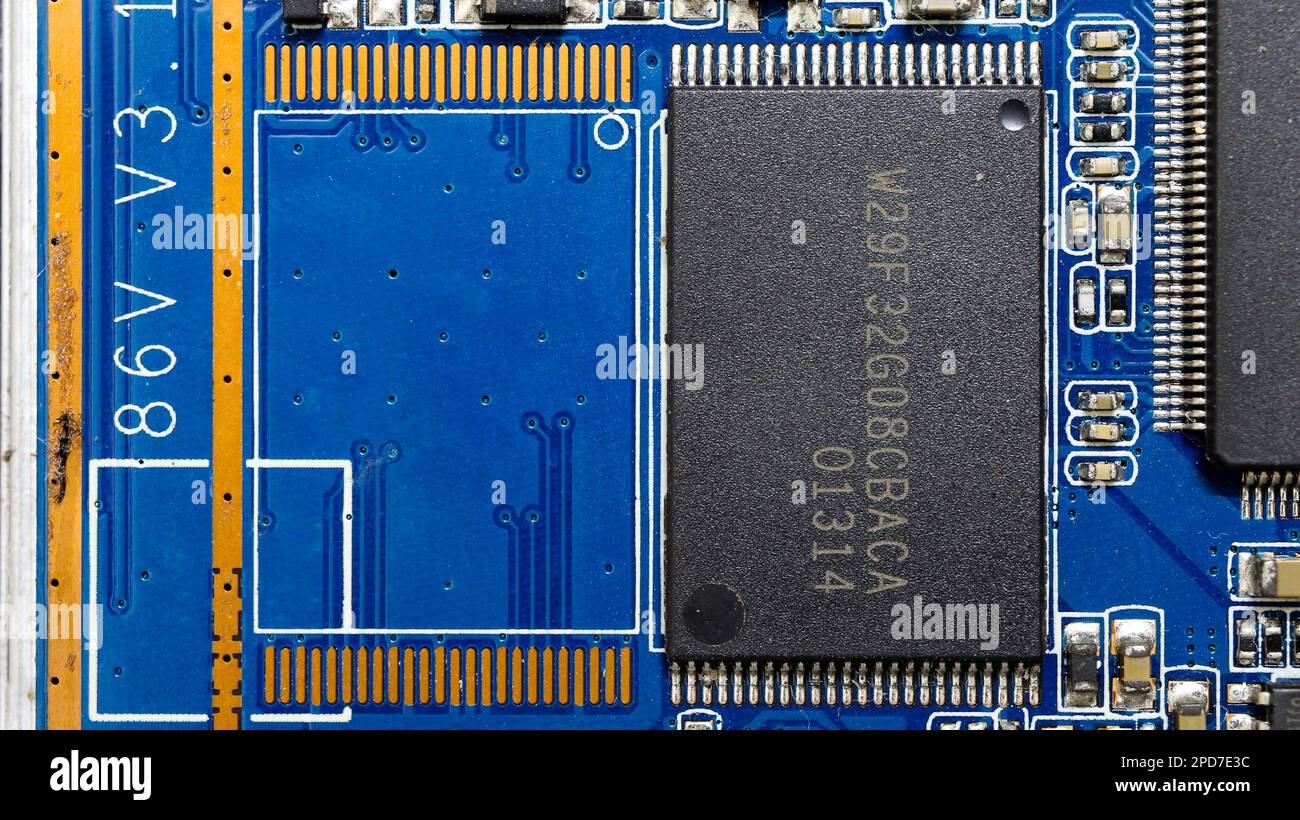 A close-up of a tiny computer chip connected to a blue and white ...