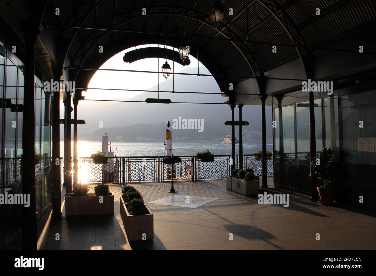 Lake Como Ferry dock passenger pavilion, view toward the lake in sunset ...