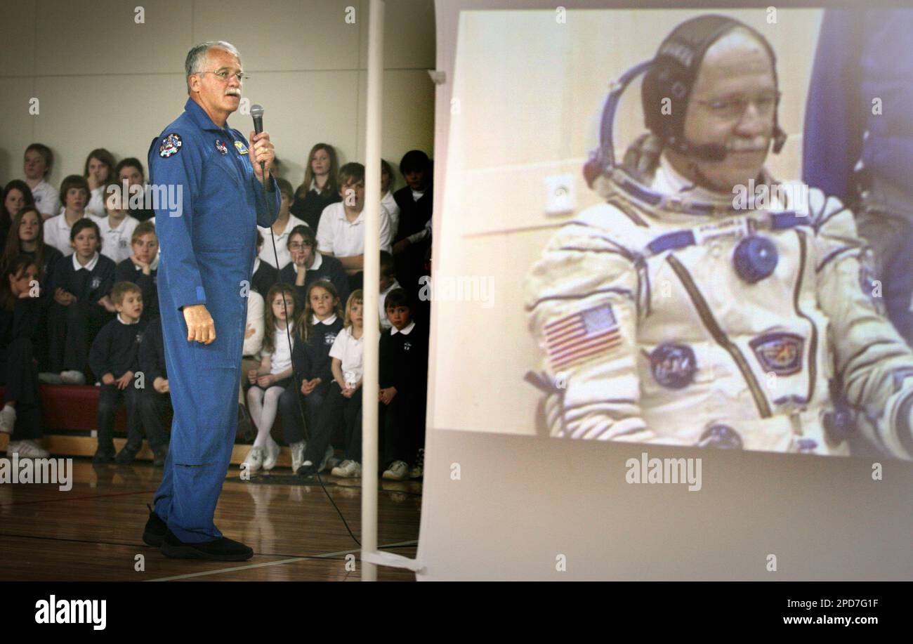 NASA astronaut John Phillips shows a video and speaks to students about ...