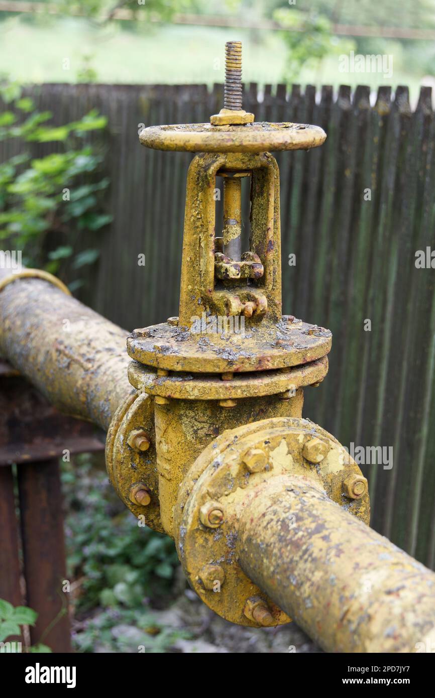 Gas pipe with large old valve-crane. Industrial gas pipeline laid along ...