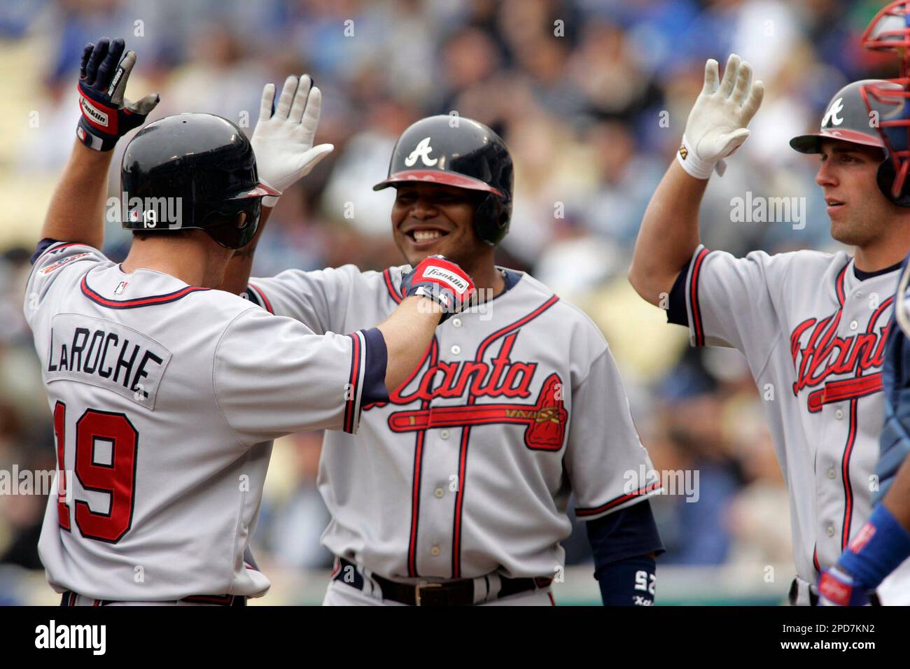 Atlanta Braves' Adam LaRoche, left, is greeted at home plate by ...