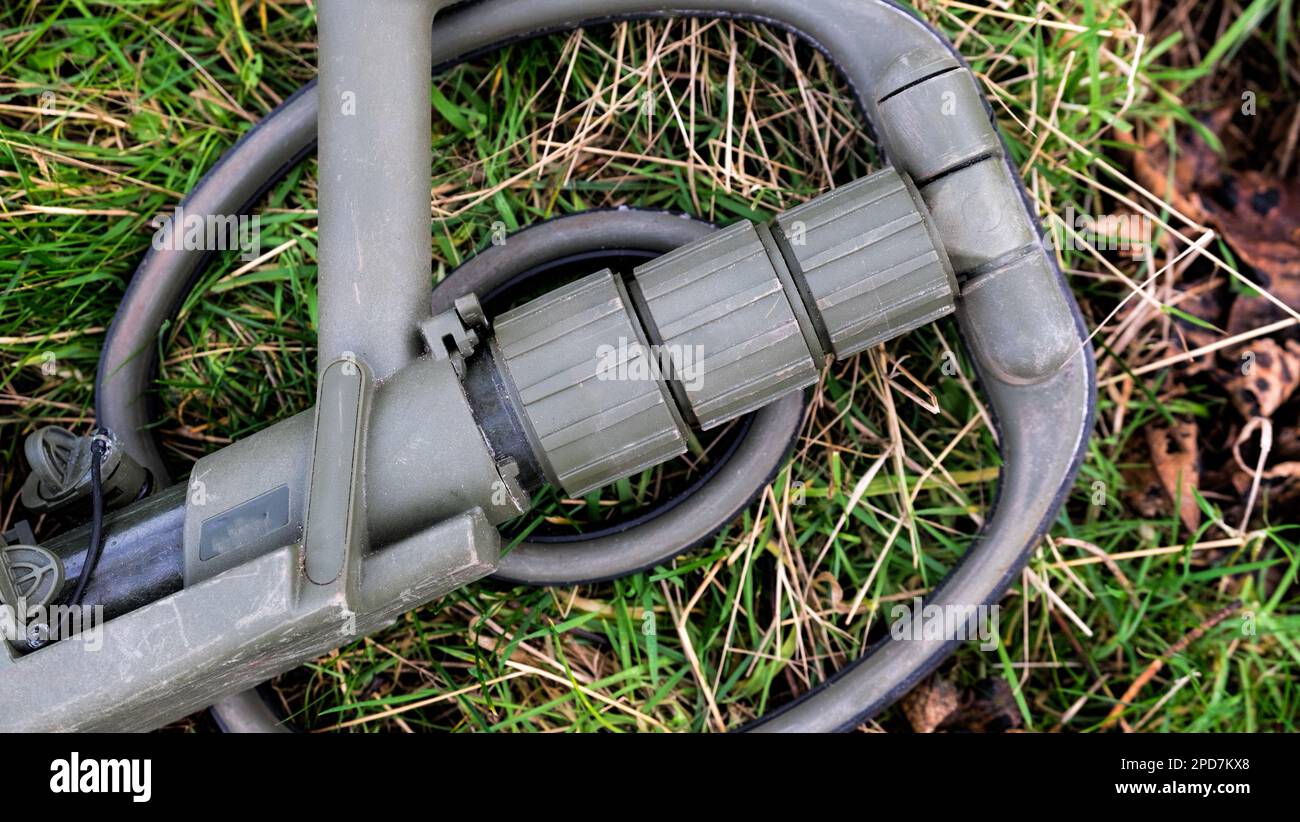 Metal detector lying on grass Stock Photo - Alamy