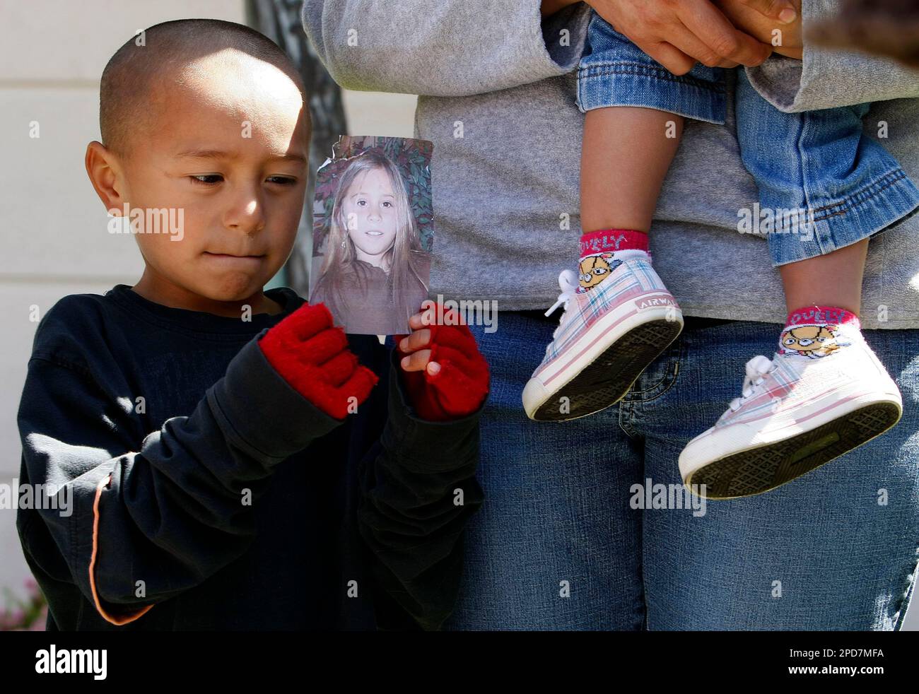 Five-year-old Bradly Flores of Tracy holds a photo of 8-year-old Sandra ...