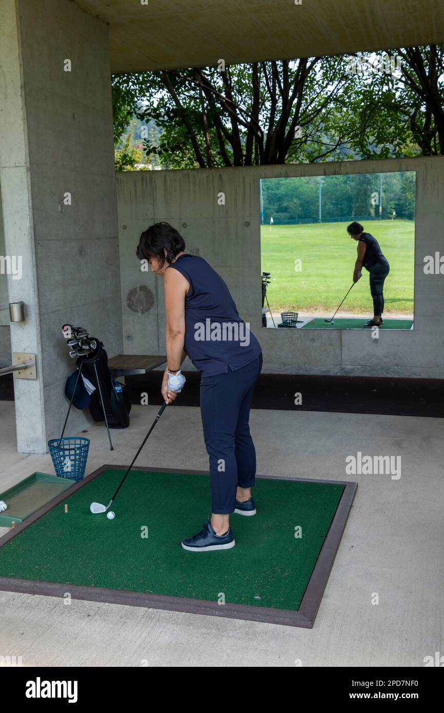 Golfer Practice in Driving Range and a Golf Bag with Golf Clubs and ...