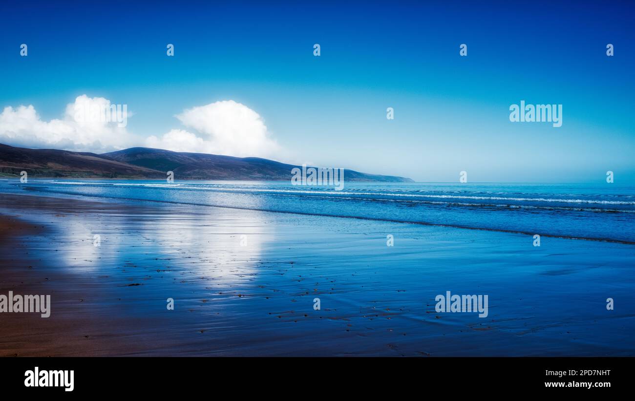 Clouds reflected in wet sand on Brora beach Stock Photo - Alamy