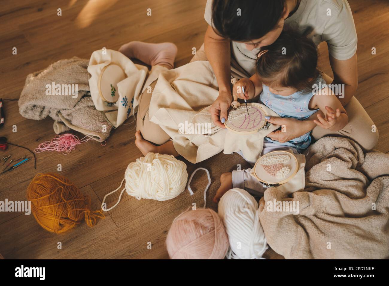 Top view of a mother teaching child crafting, hobby for family with ...