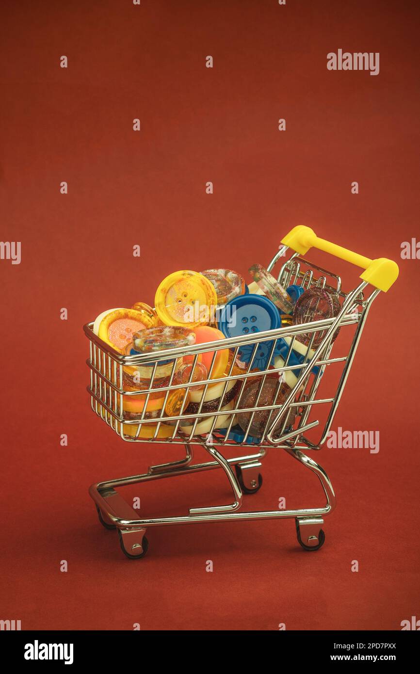 Multi-colored buttons of different shapes in a shopping cart. Lots of ...