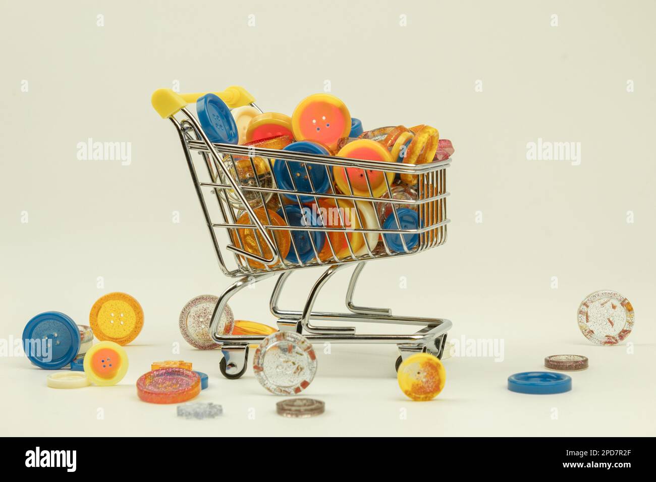 Multi-colored buttons of different shapes in a shopping cart. Lots of ...