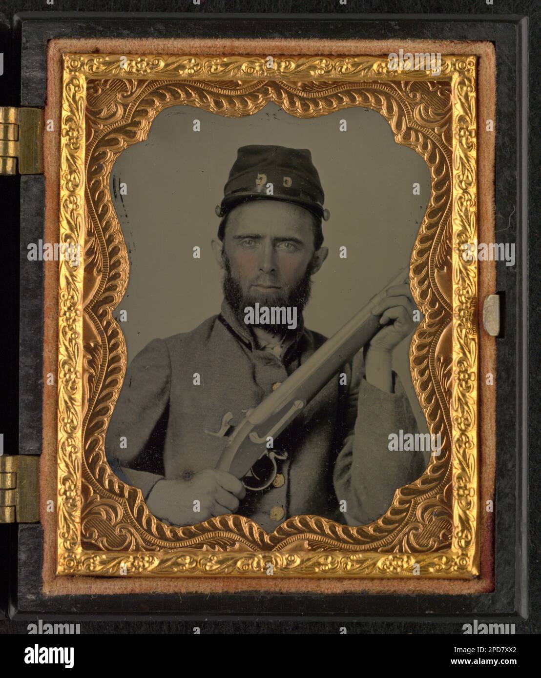 Unidentified soldier in Confederate uniform and hat with initials CG ...