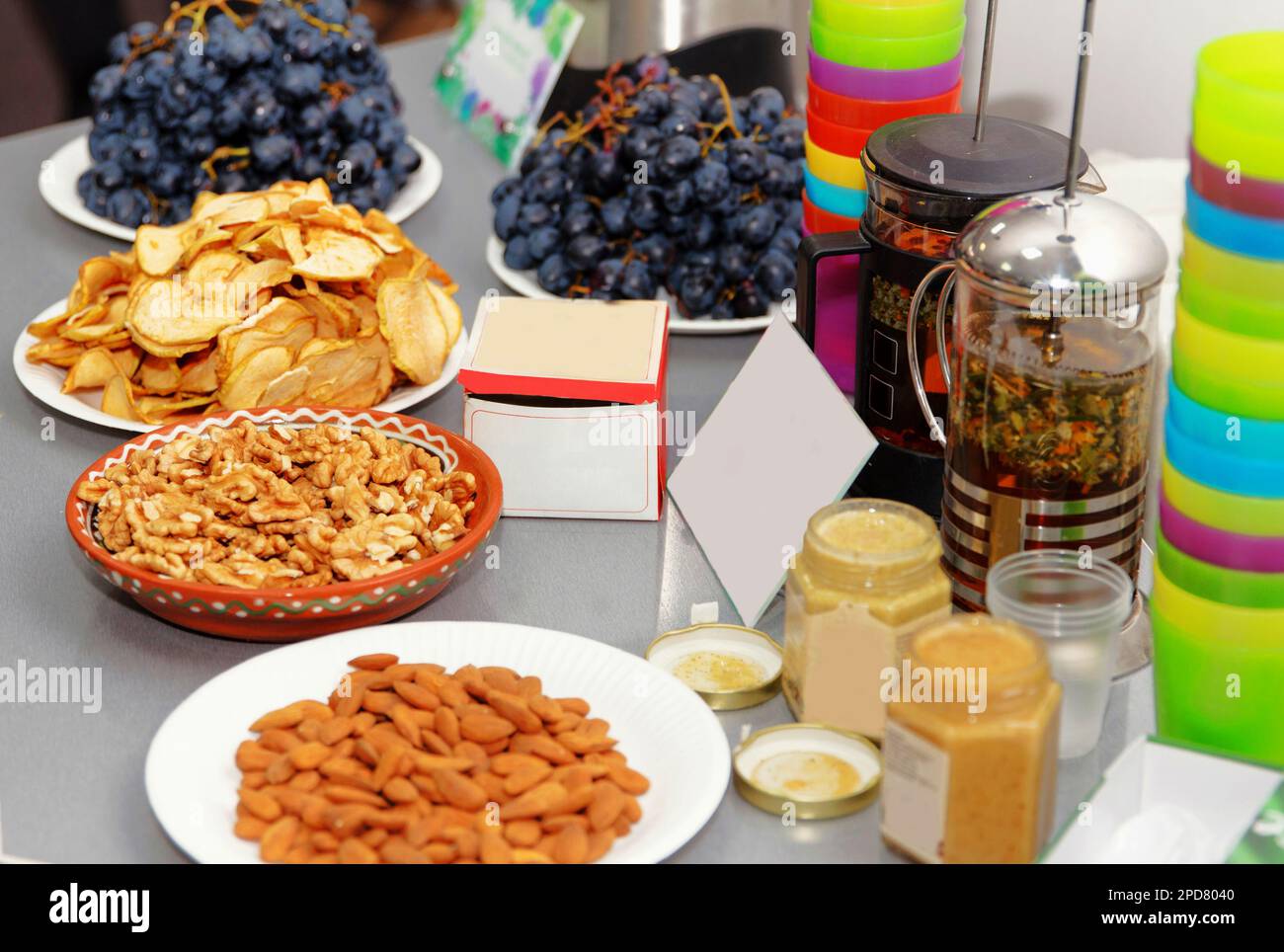 Buffet table with a treat of herbal tea, dried fruit, nuts and honey ...