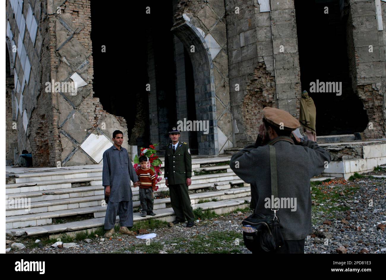 A street photographer takes a picture of a group of people in front of ...