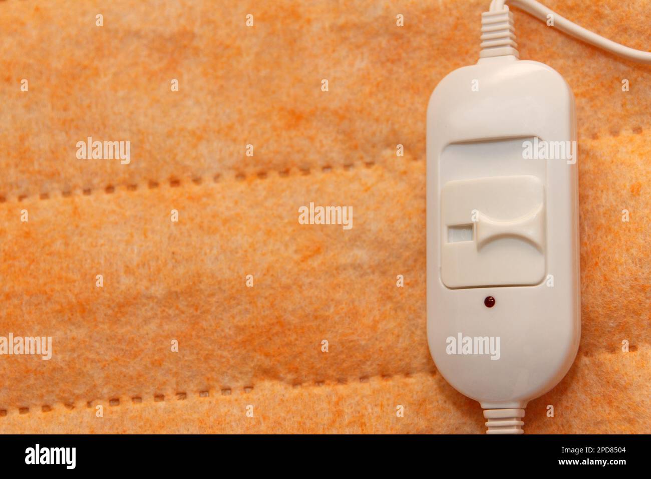 A warm beauty orange new electric sheet, lies assembled, and on top of ...