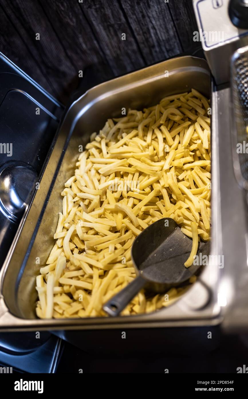Metal container filled with the french fries and shovel on a christmas ...